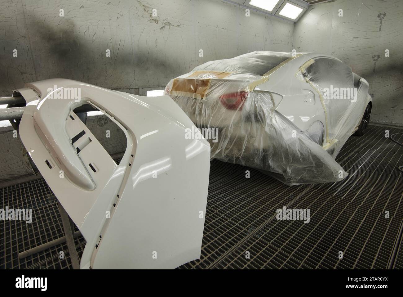 The photograph captures the scene of an automotive workshop, showcasing ...
