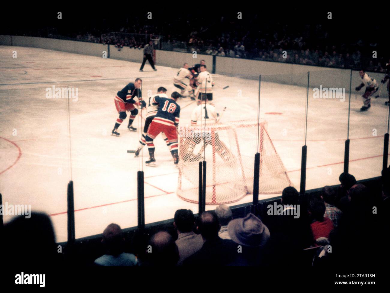 NEW YORK, NY - 1958: Gerry Foley #18 of the New York Rangers battles ...