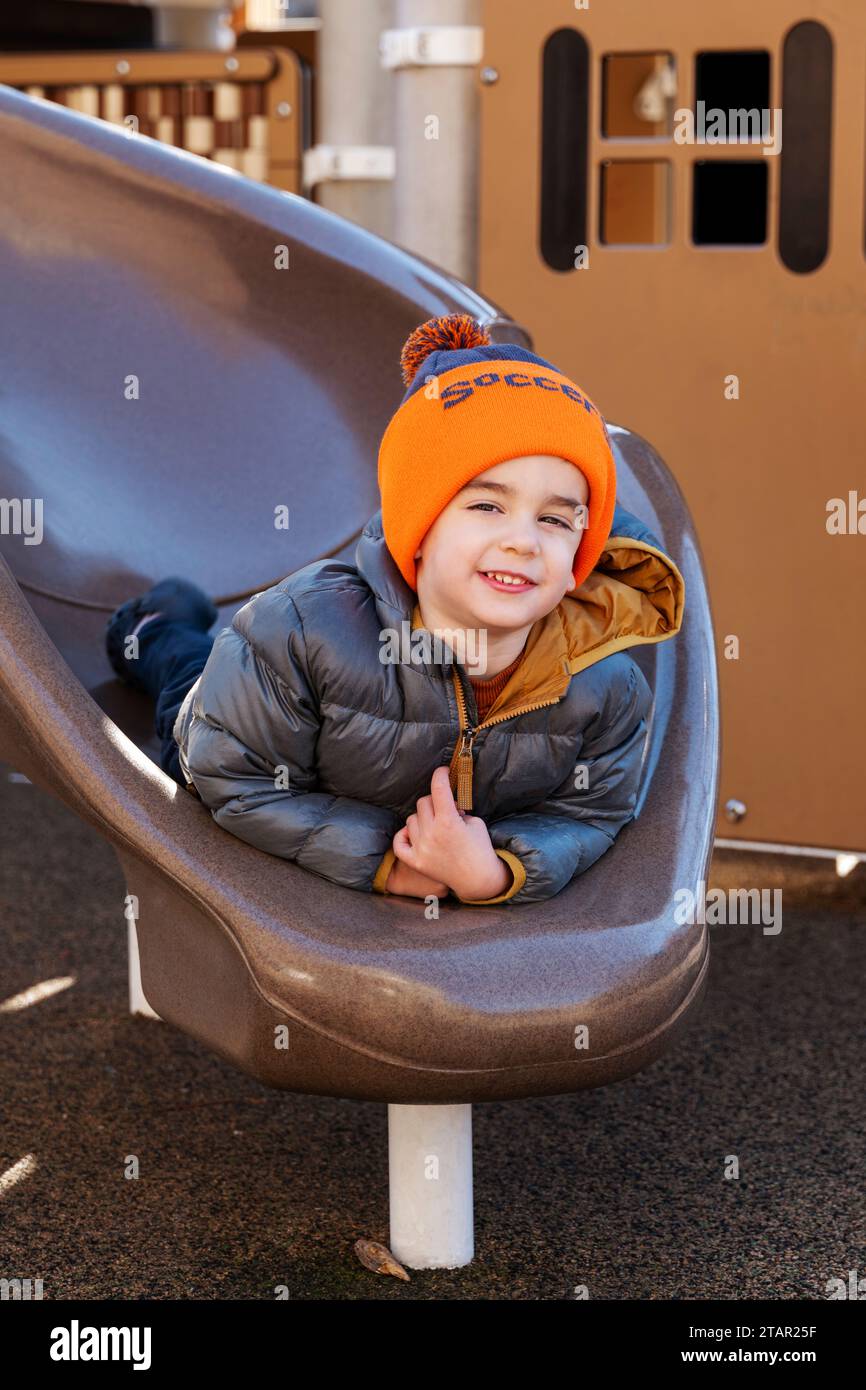 Young child playing on sliding board; outdoors playground; Philadelphia ...