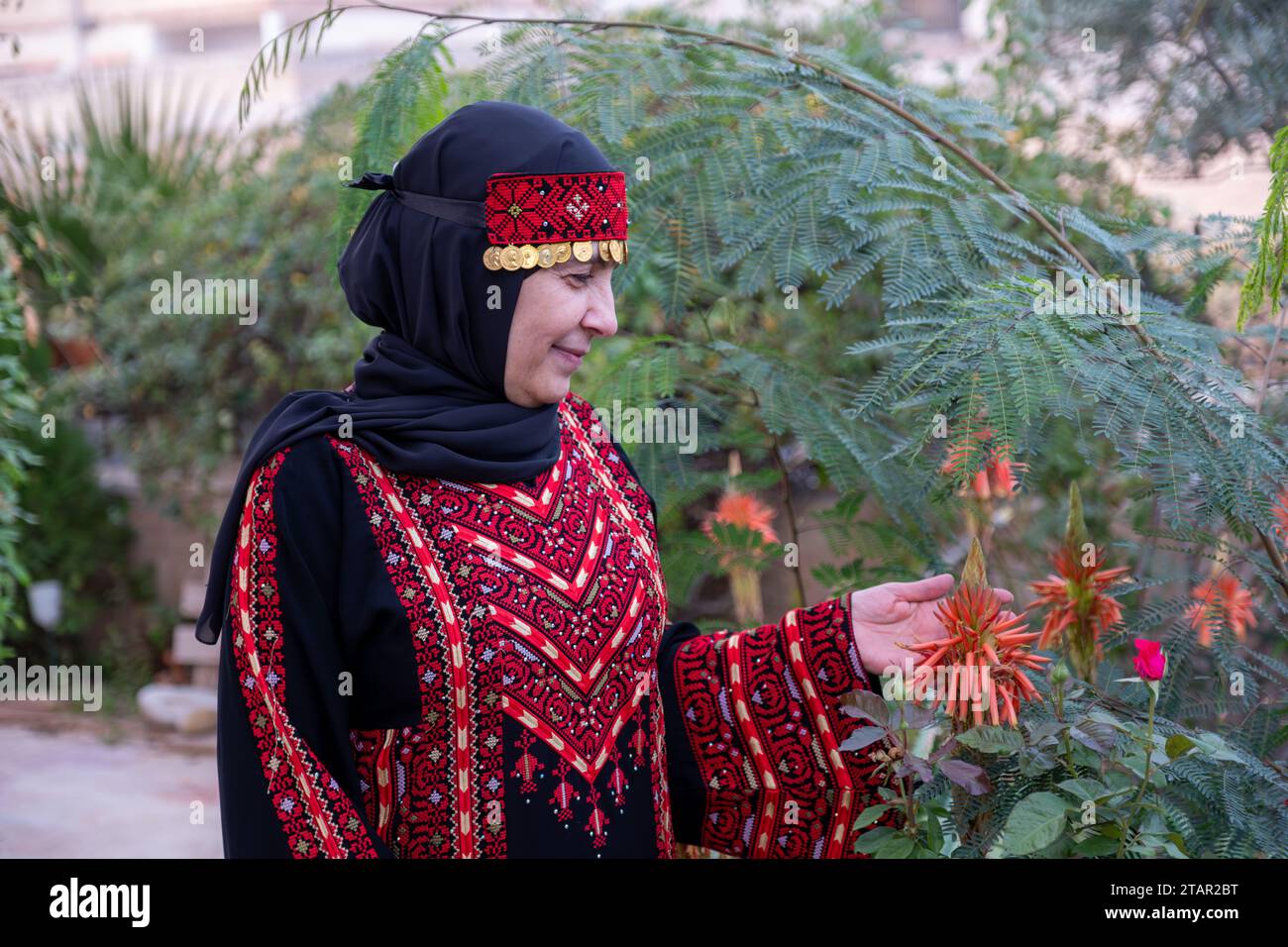 Female wearing palestinian clothes with flowers and roses around Stock ...