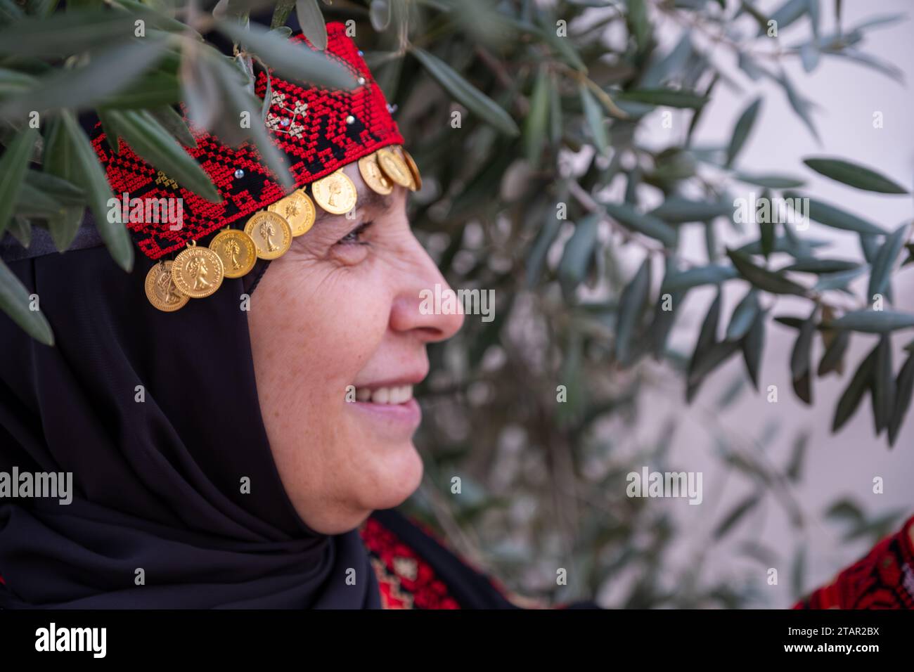 Portrait Of woman wearing palestinian traditional clothes in olive ...