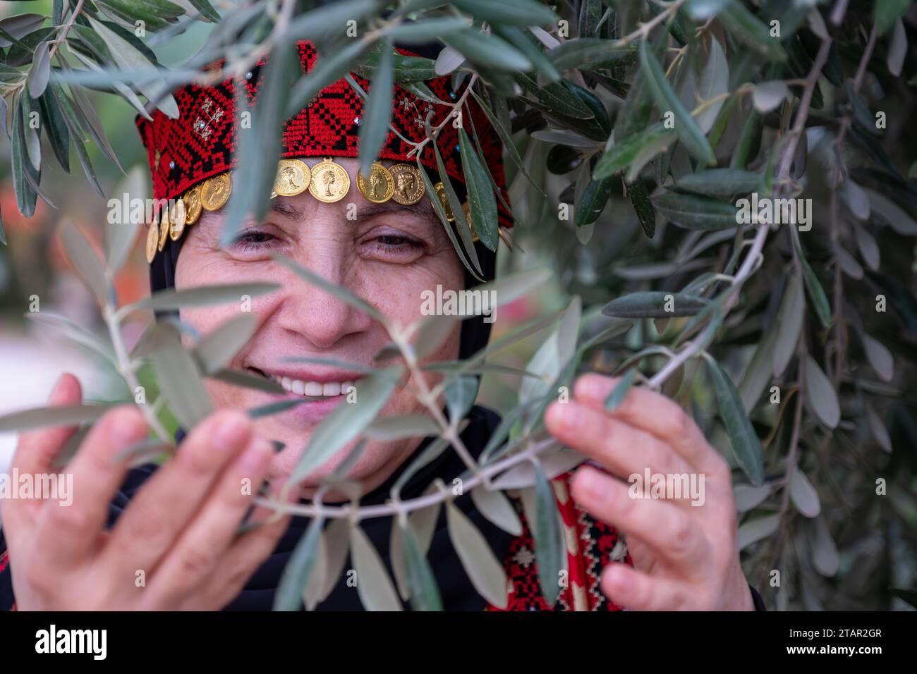 Portrait Of woman wearing palestinian traditional clothes in olive ...