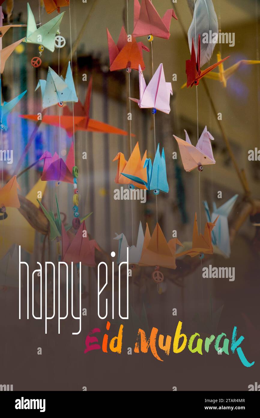 Colorful paper origami birds tied to strings hanging in air Stock Photo ...