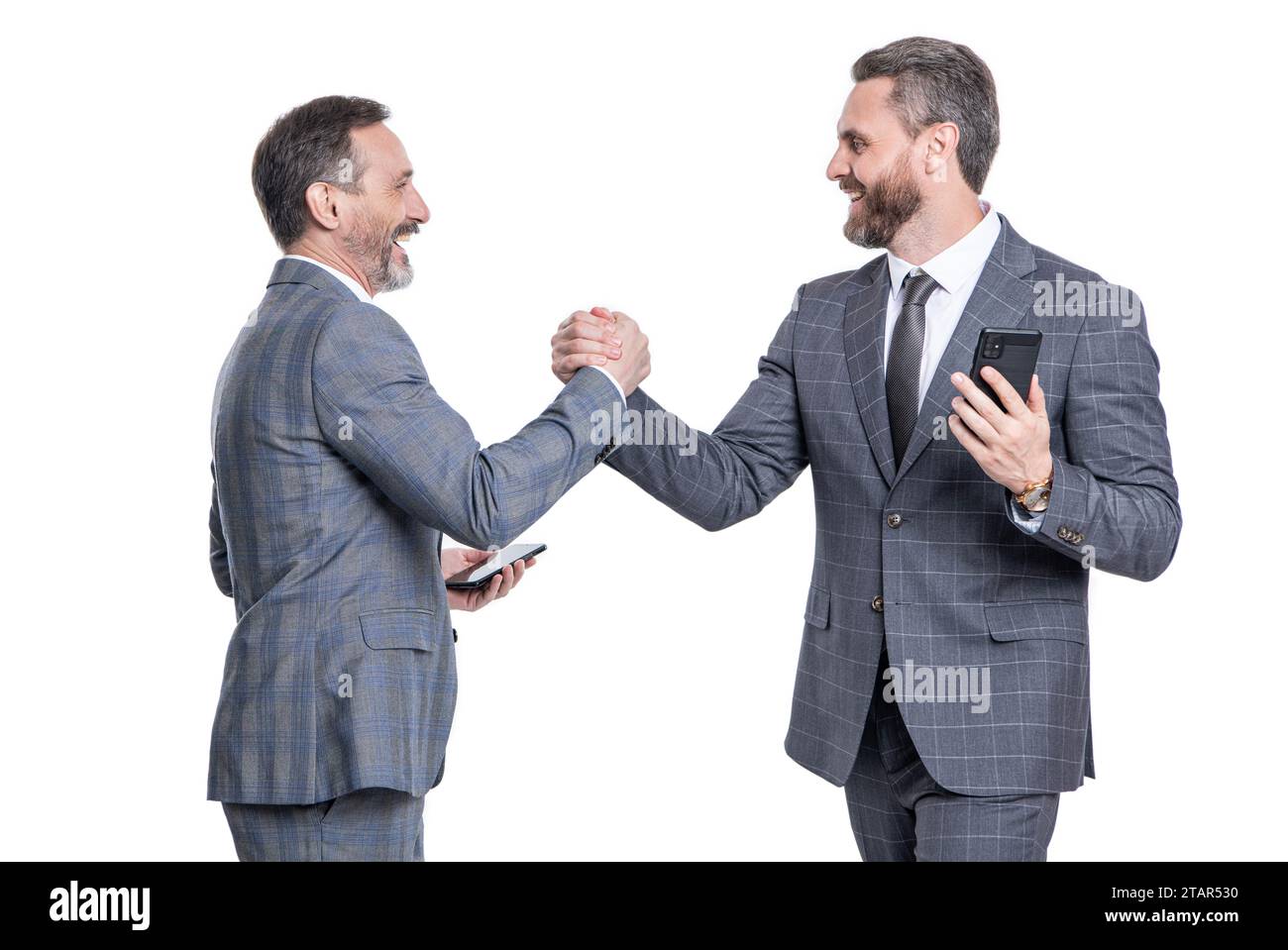 collaboration success. two businessmen handshaking after successful ...