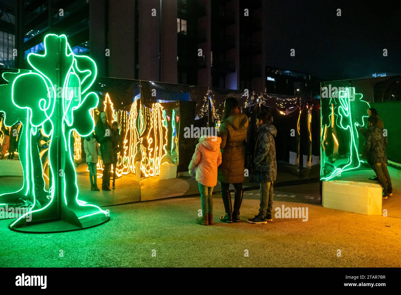 London, UK. 2 December 2023. Visitors enjoy The Luminaze, a new light ...