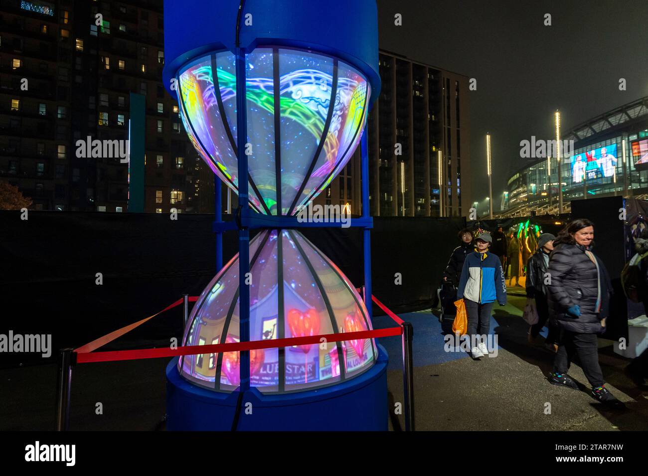 London, UK. 2 December 2023. Visitors enjoy The Luminaze, a new light ...
