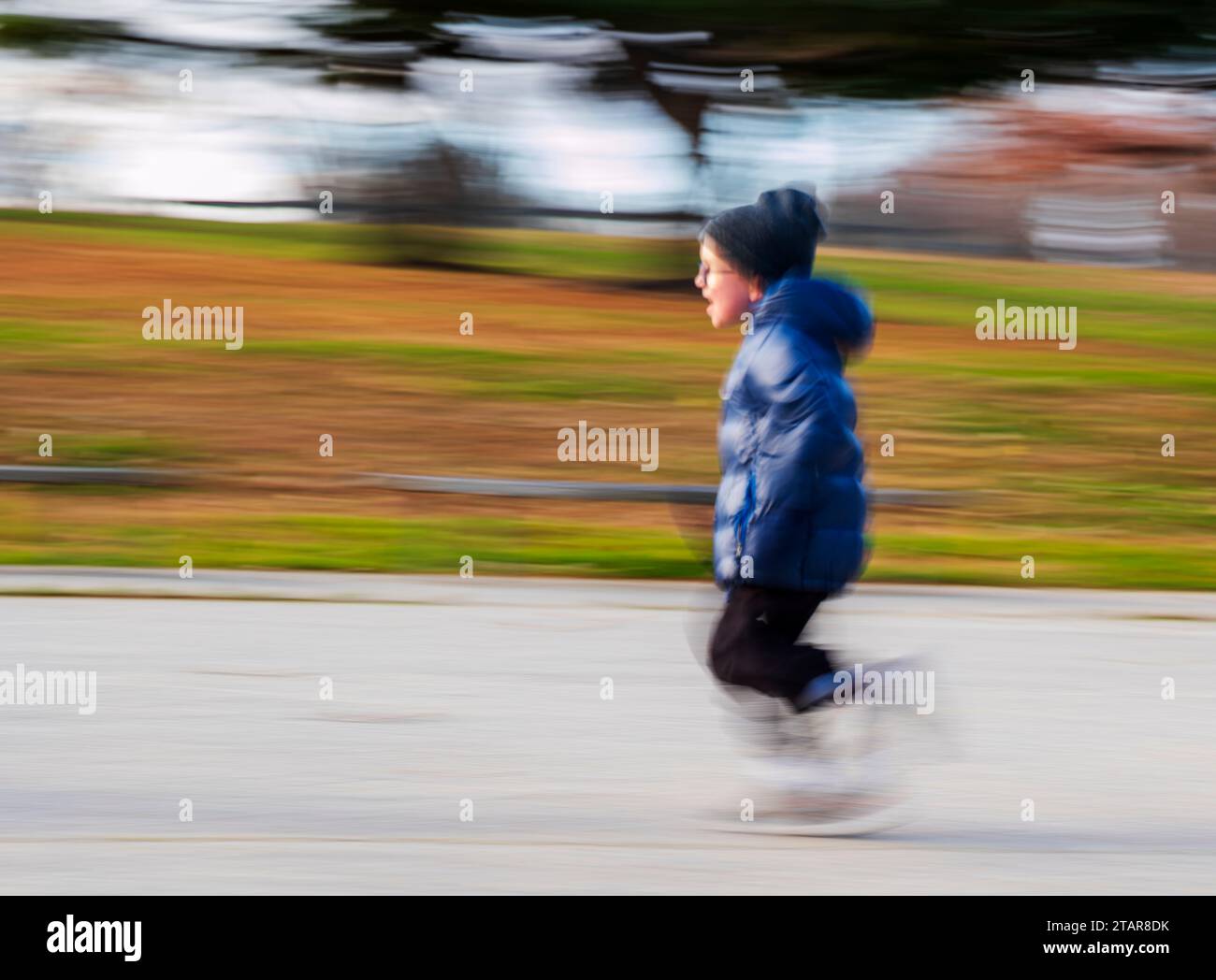 Autumn pan motion blur of young boy running on playground; Philadelphia ...
