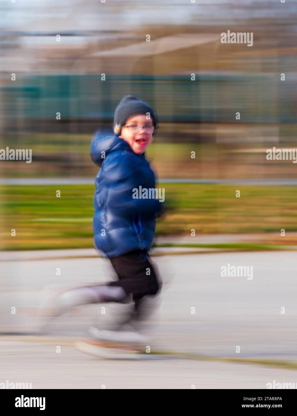 Autumn pan motion blur of young boy running on playground; Philadelphia ...