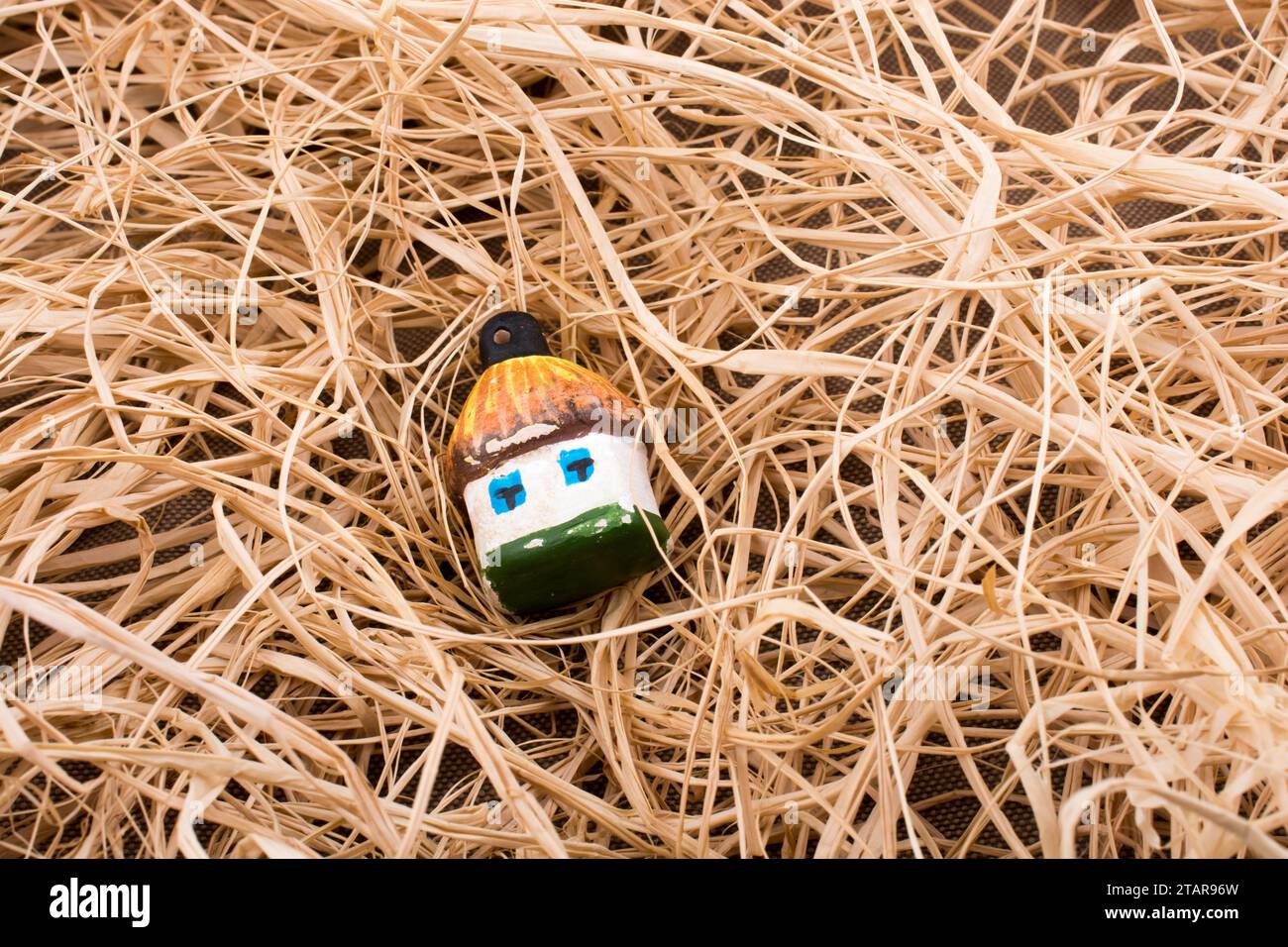 Little toy model hut placed on straw background Stock Photo - Alamy