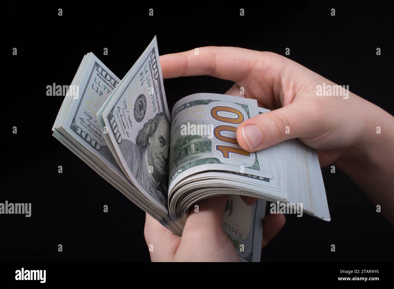 Hand holding American dollar banknotes isolated on white background ...