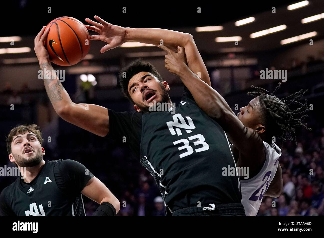 Kansas State forward Macaleab Rich (23) tries to steal the ball from ...