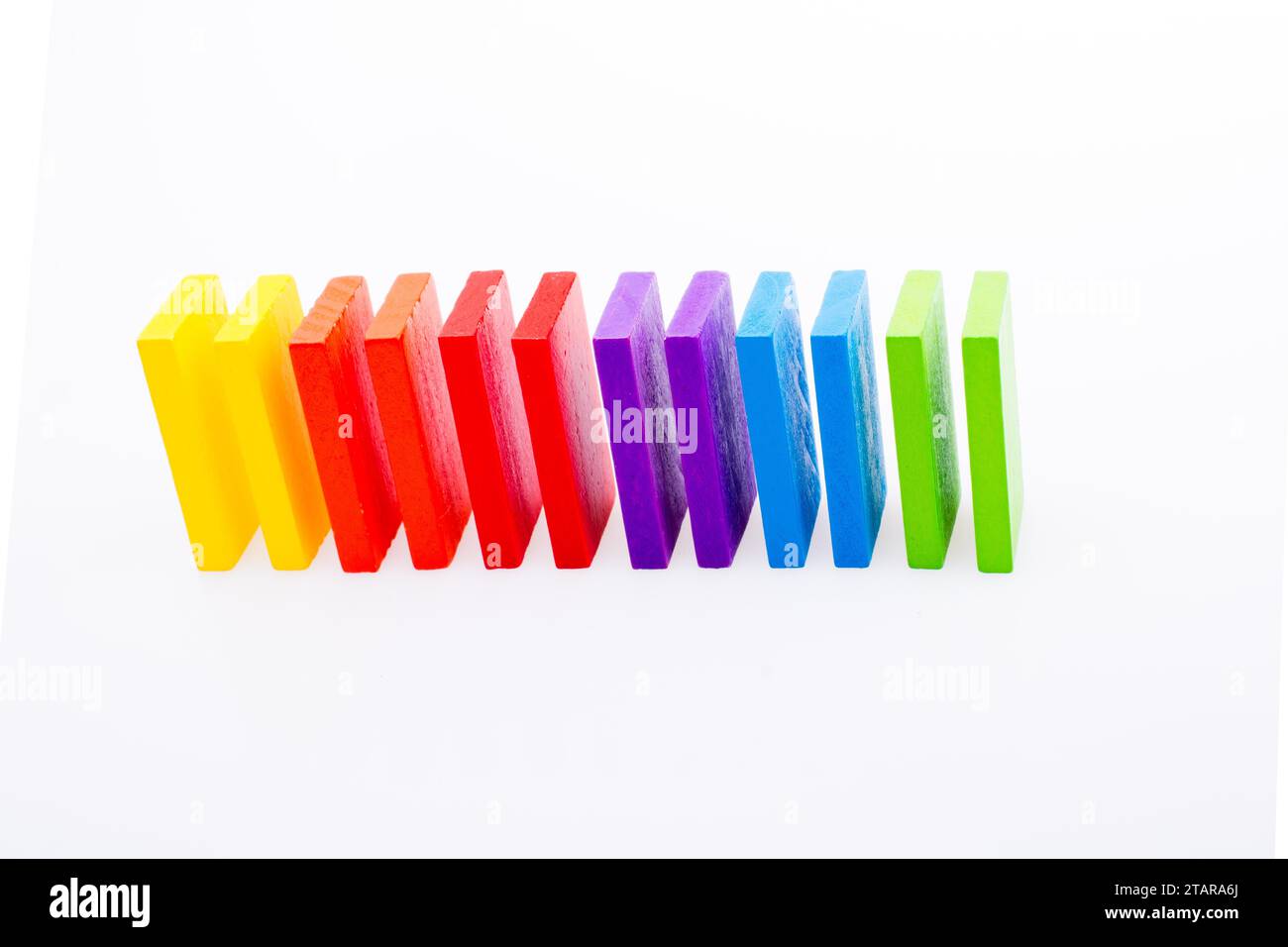 Colorful Domino Blocks in a line on a white background Stock Photo - Alamy