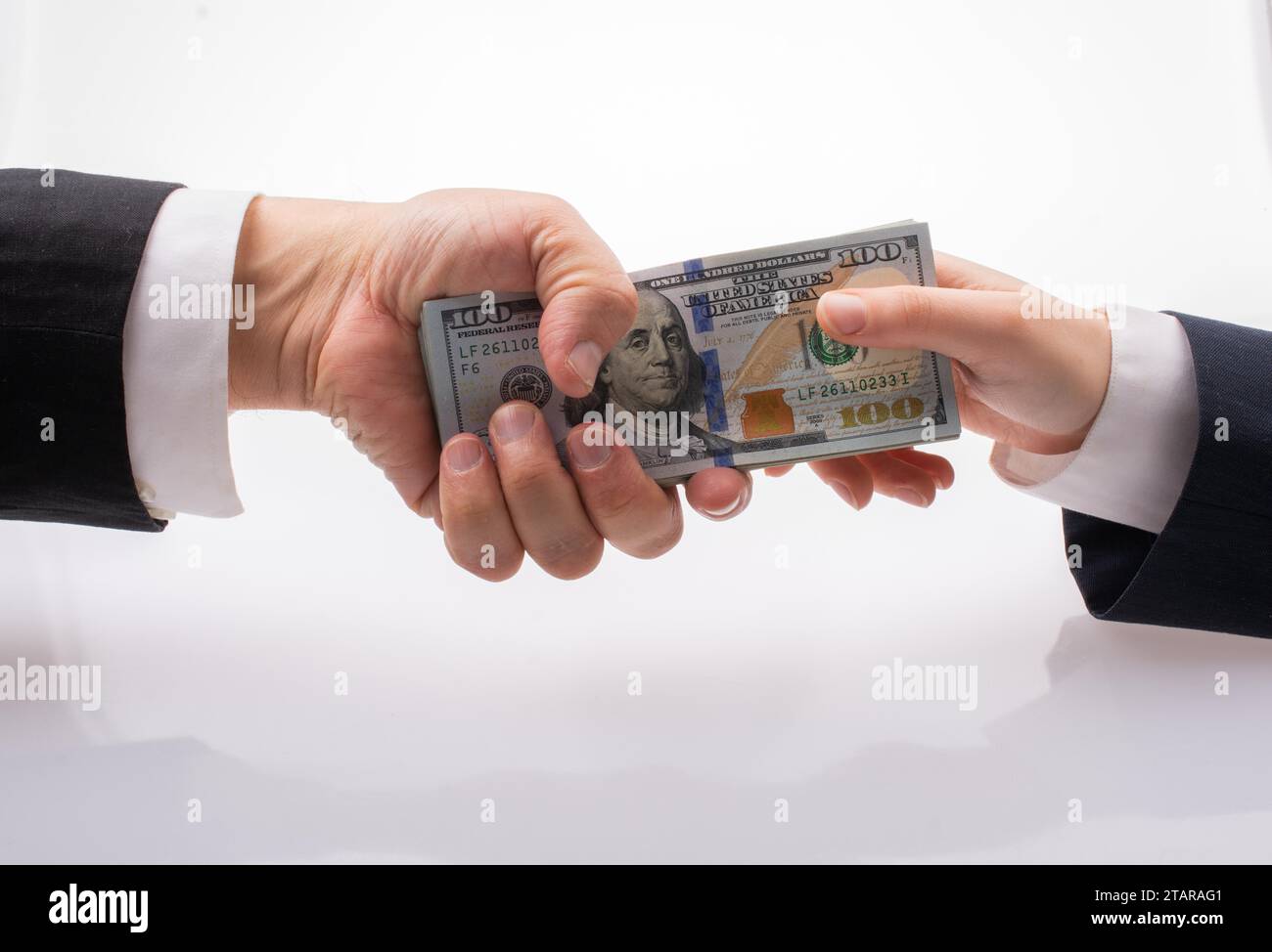 Businessman giving and receiving US dollar banknote money Stock Photo ...