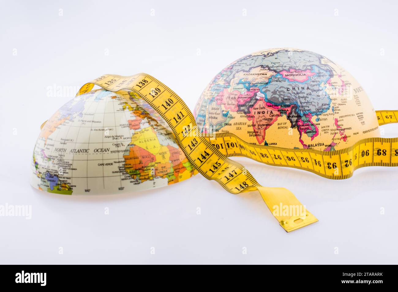 Yellow color measuring tape andglobe in two on a white background Stock ...