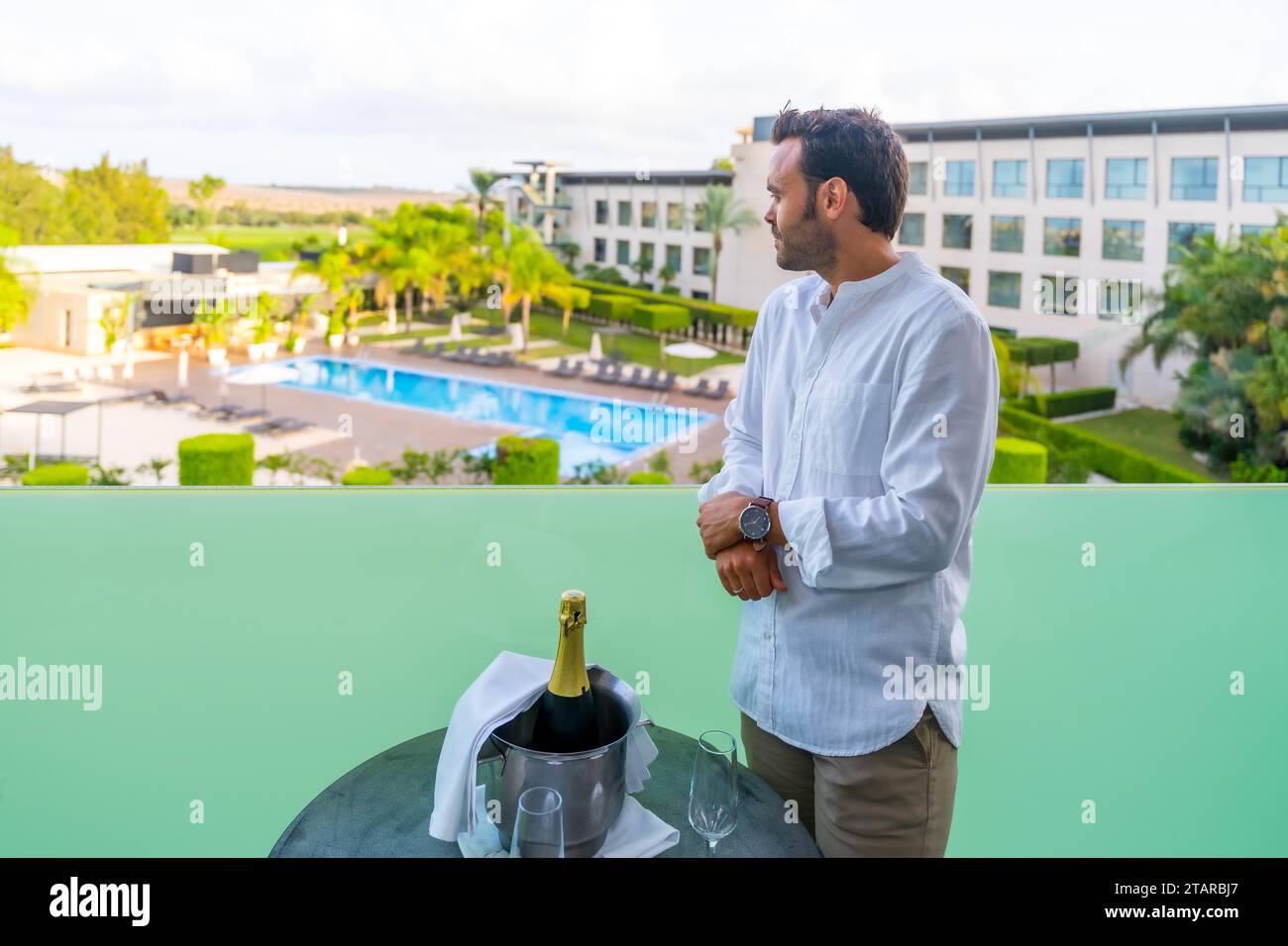 Man preparing a romantic toast with champagne in the hotel terrace ...