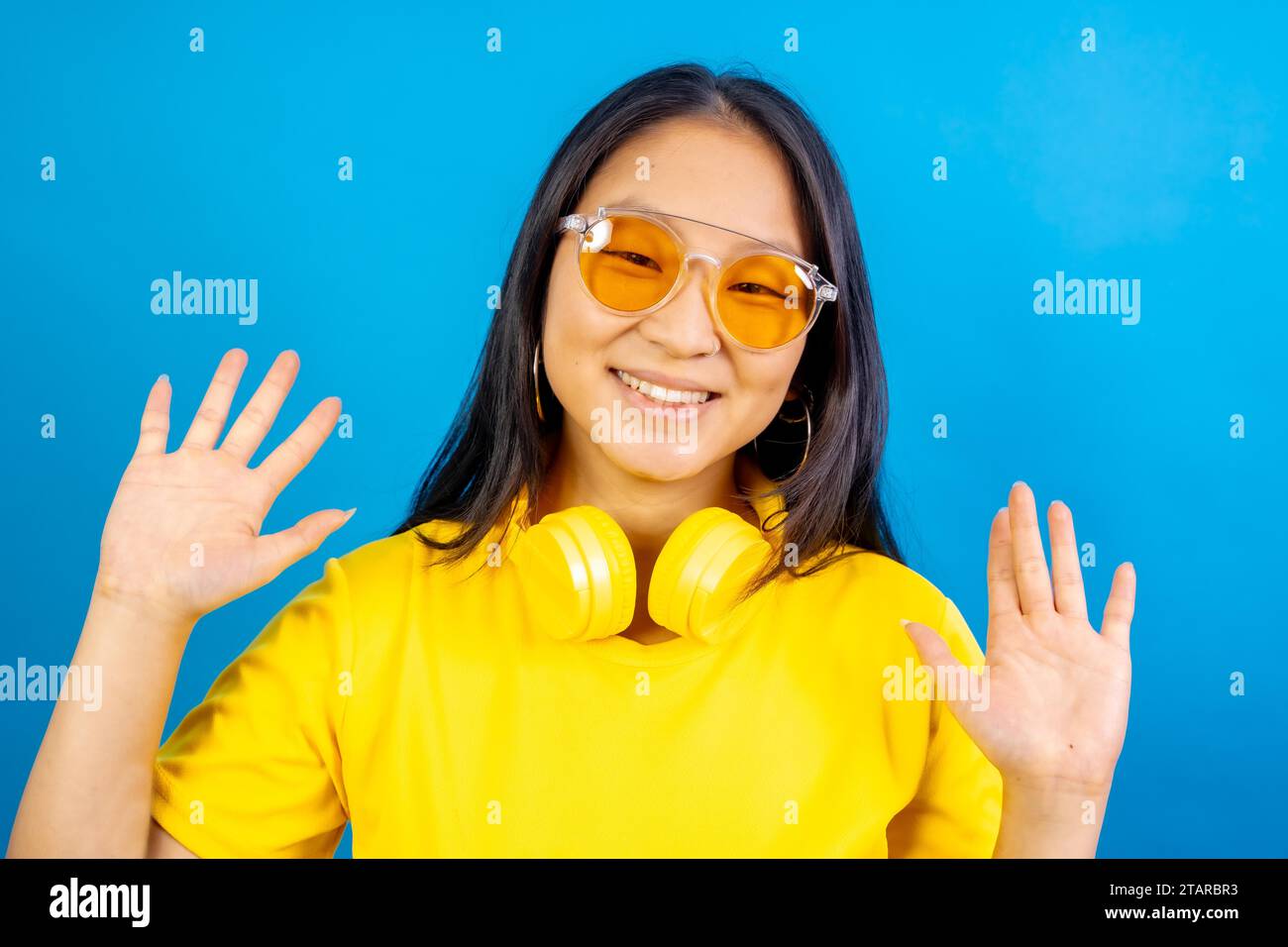 Studio photo with blue background of a happy chinese woman with ...