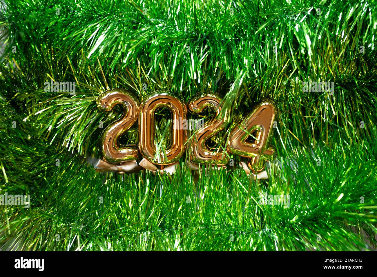 Happy New Year 2024 - Orange gold numbers on light green glitter grass ...