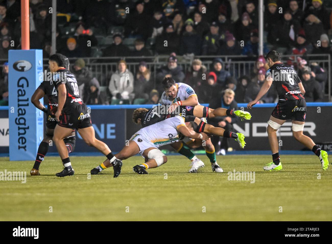 Andy Christie of Saracens is tackled and lifted horizontally off the ...