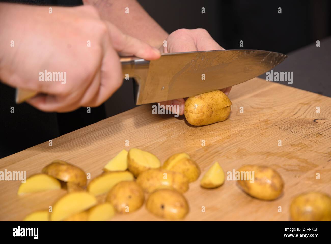 Cook cuts vegetables in kitchen hi-res stock photography and images - Alamy