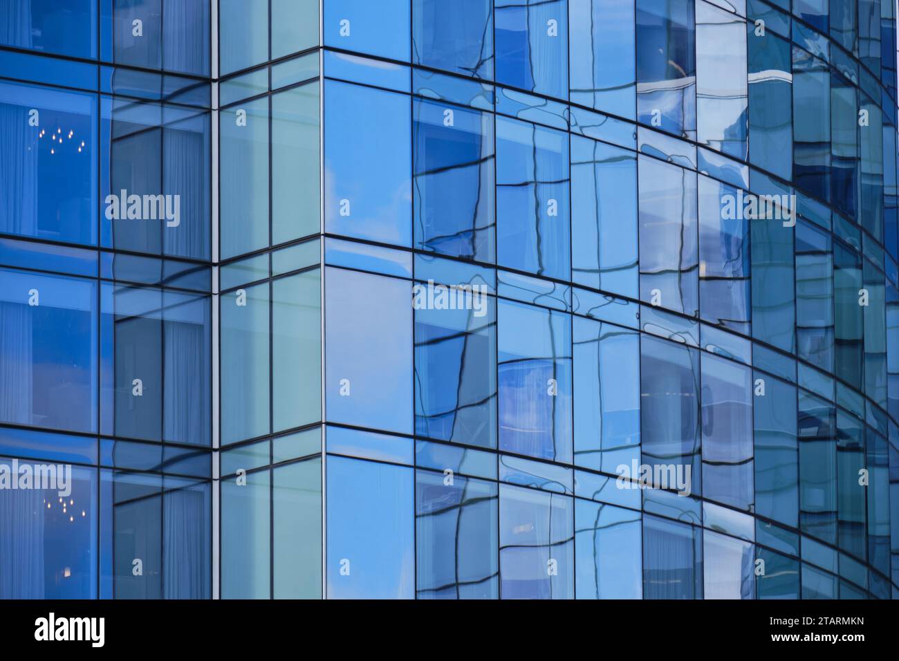 view of mid floors of glass high rise building with angles in downtown ...