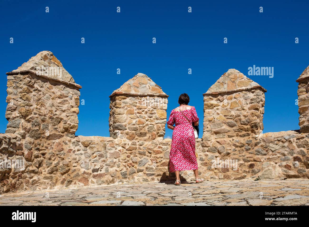 Woman walking on the ramparts of the fortified city walls in the ...