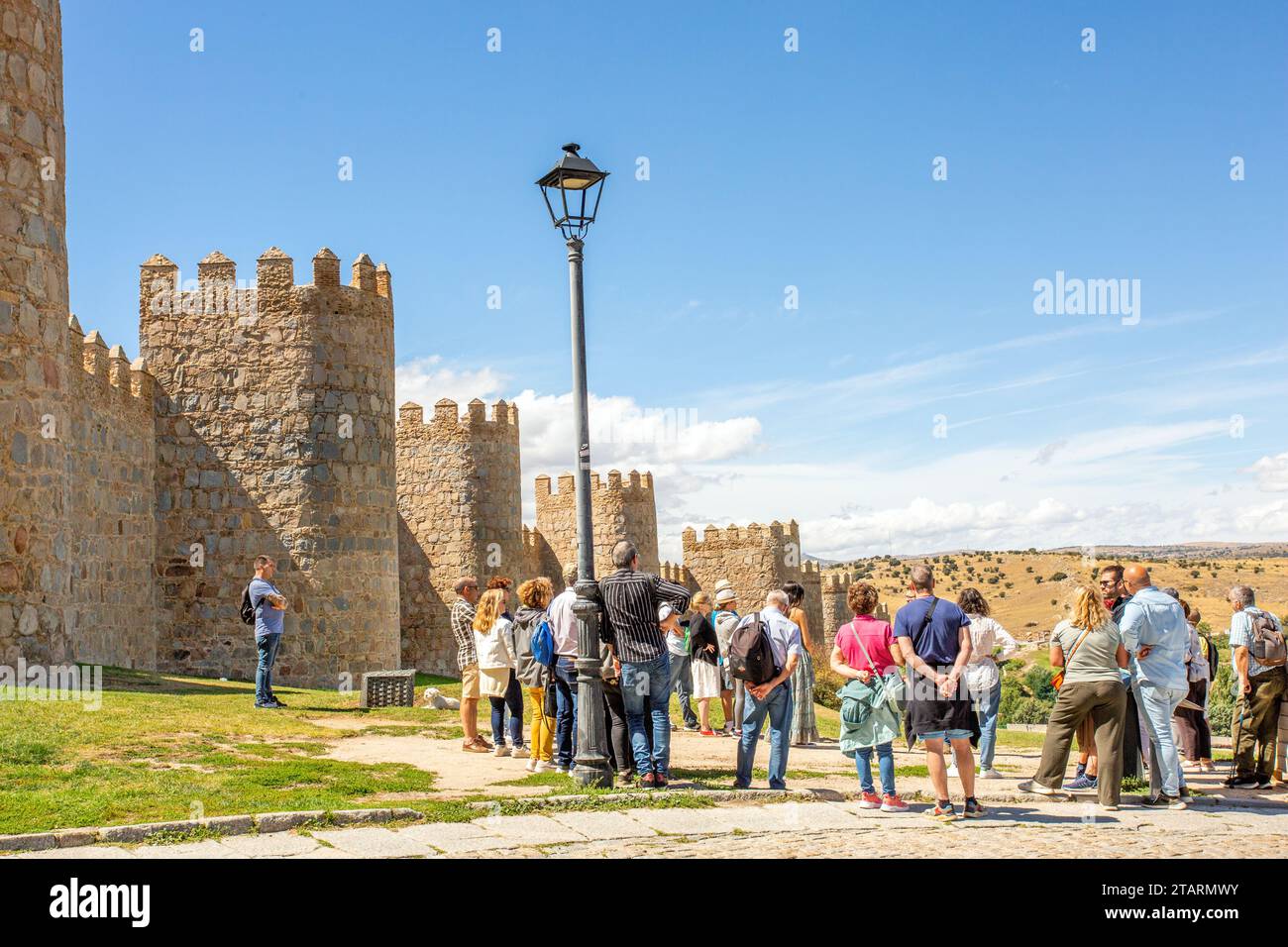 Tourists on a guided walk by the ramparts of the fortified city walls ...