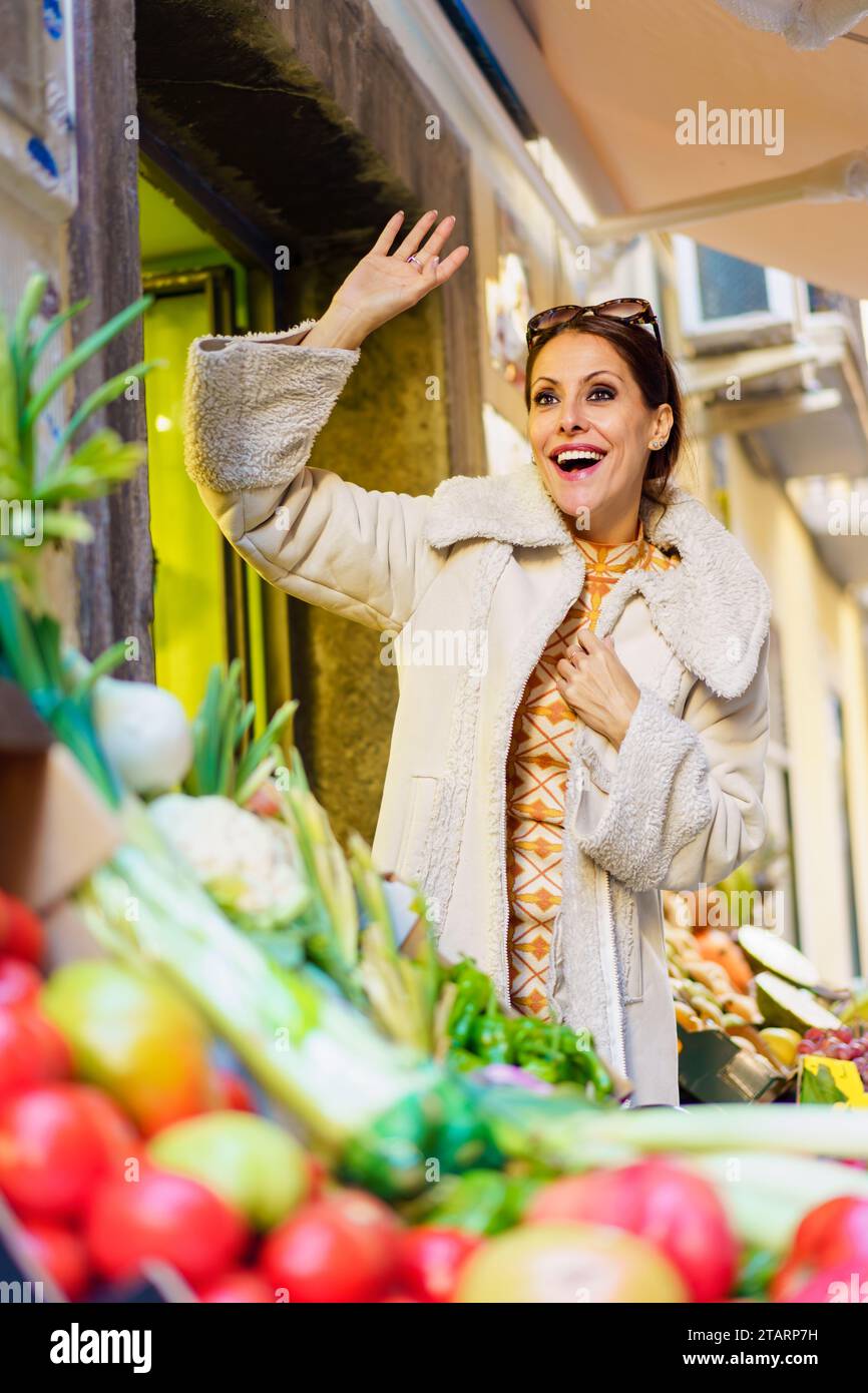 Excited woman greeting waving hand hi-res stock photography and images ...