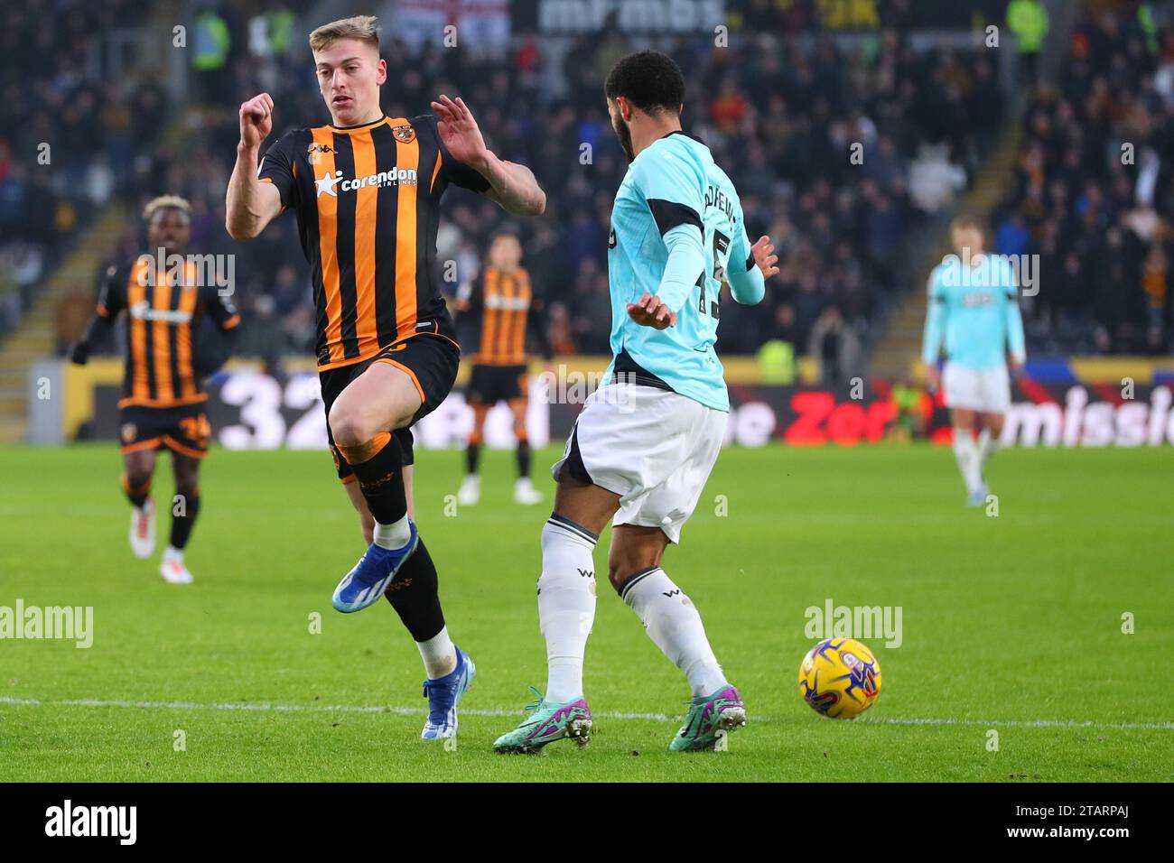 Liam Delap of Hull City plays the ball away from Ryan Andrews of ...