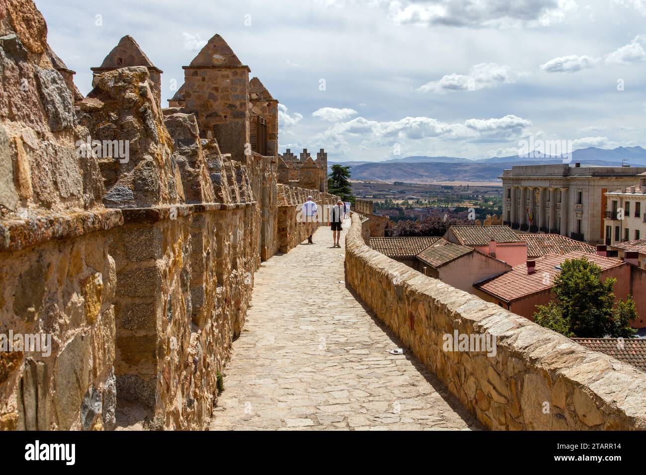 People walking on the ramparts in the Spanish walled city of Avila in ...