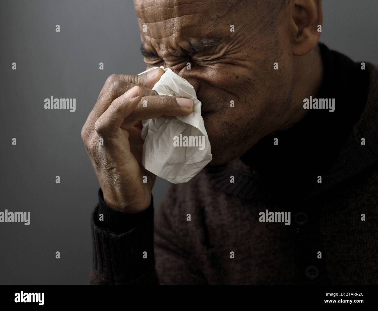 catching the cold and flu man blowing nose after catching a cold with ...