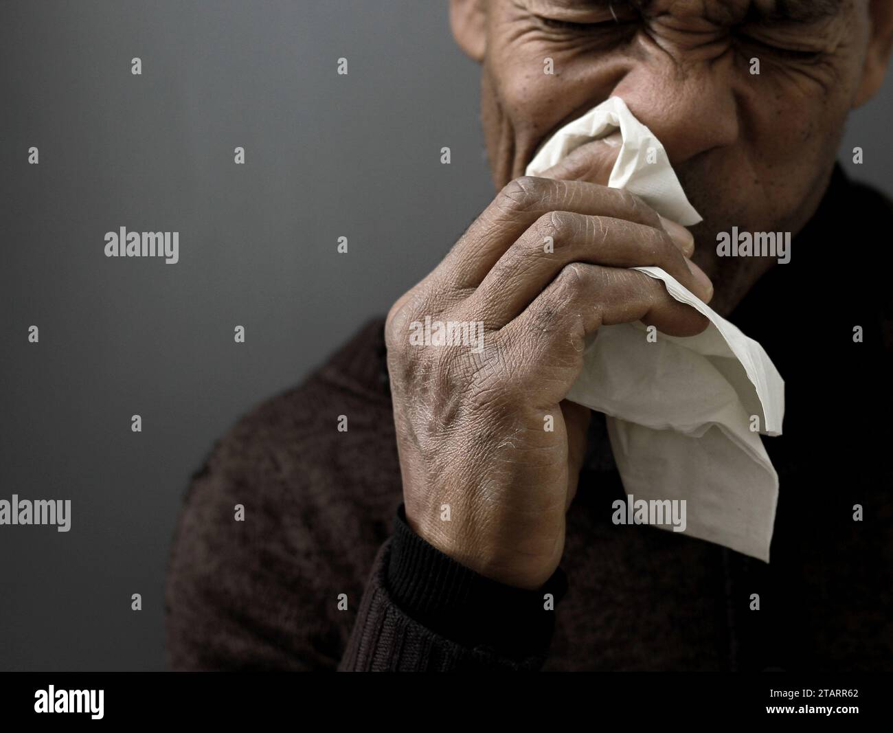 catching the cold and flu man blowing nose after catching a cold with ...