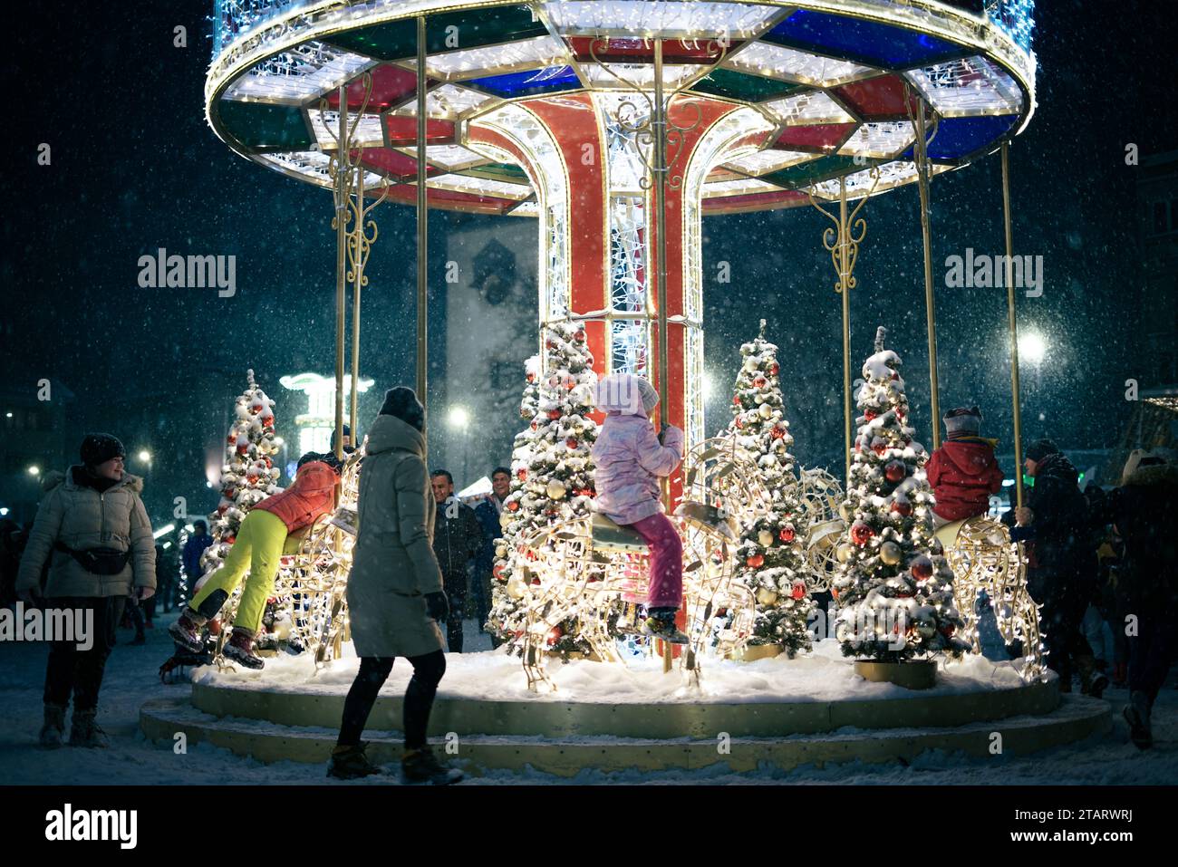 Christmas carousel with kids having fun Stock Photo - Alamy