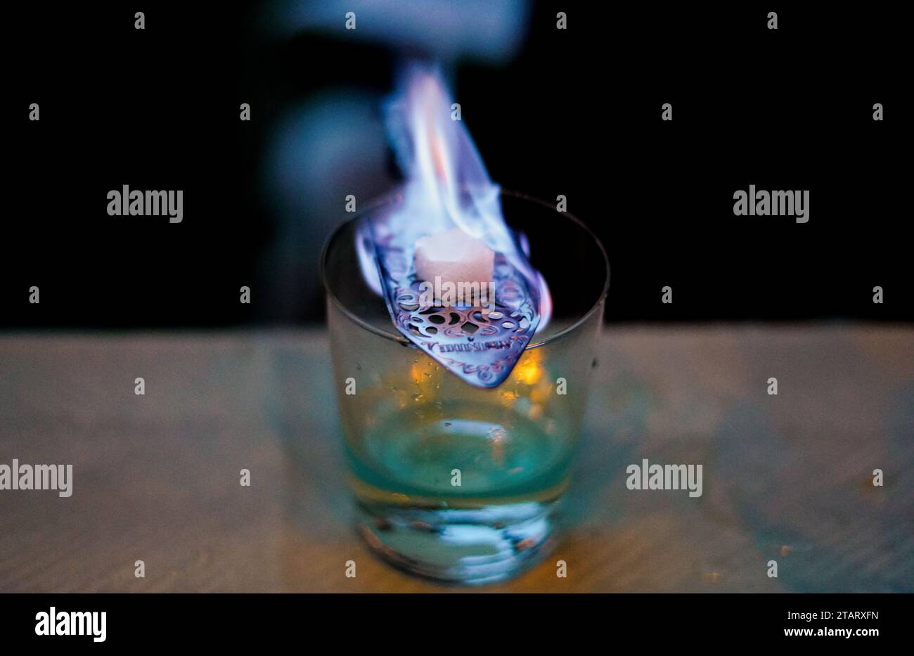 Making green absinth with fire and sugar Stock Photo - Alamy