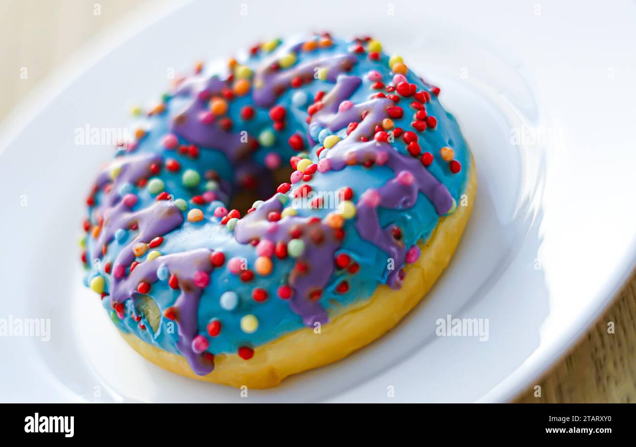 Blue donut with colorful sprinkles Stock Photo - Alamy