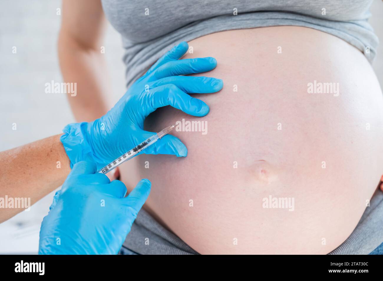 Doctor gives an injection in the stomach of a pregnant woman Stock ...
