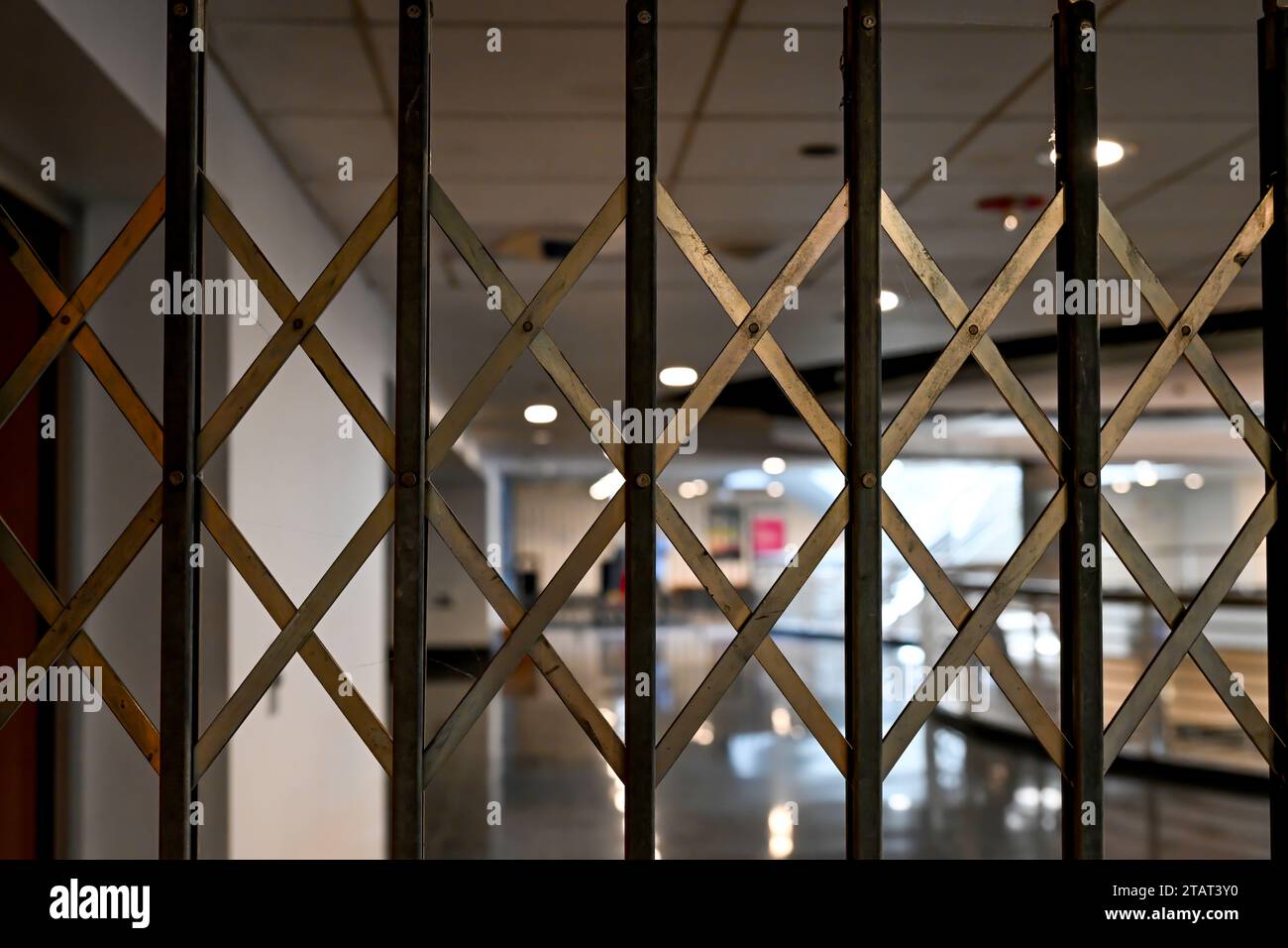 Scissor gate pulled across a hallway to close off a section of building ...