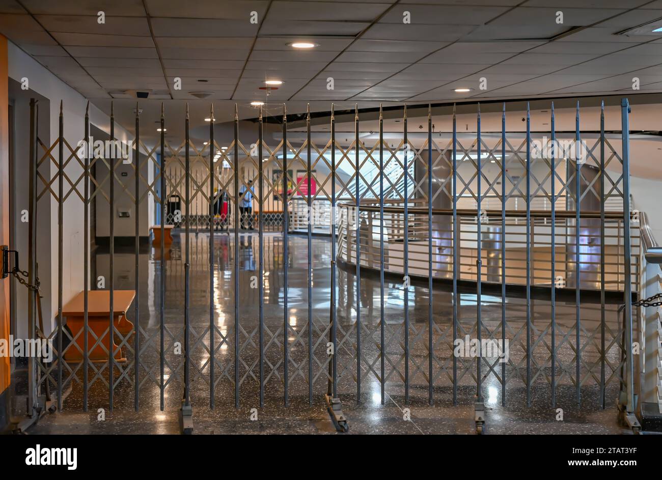 Scissor gate pulled across a hallway to close off a section of building ...