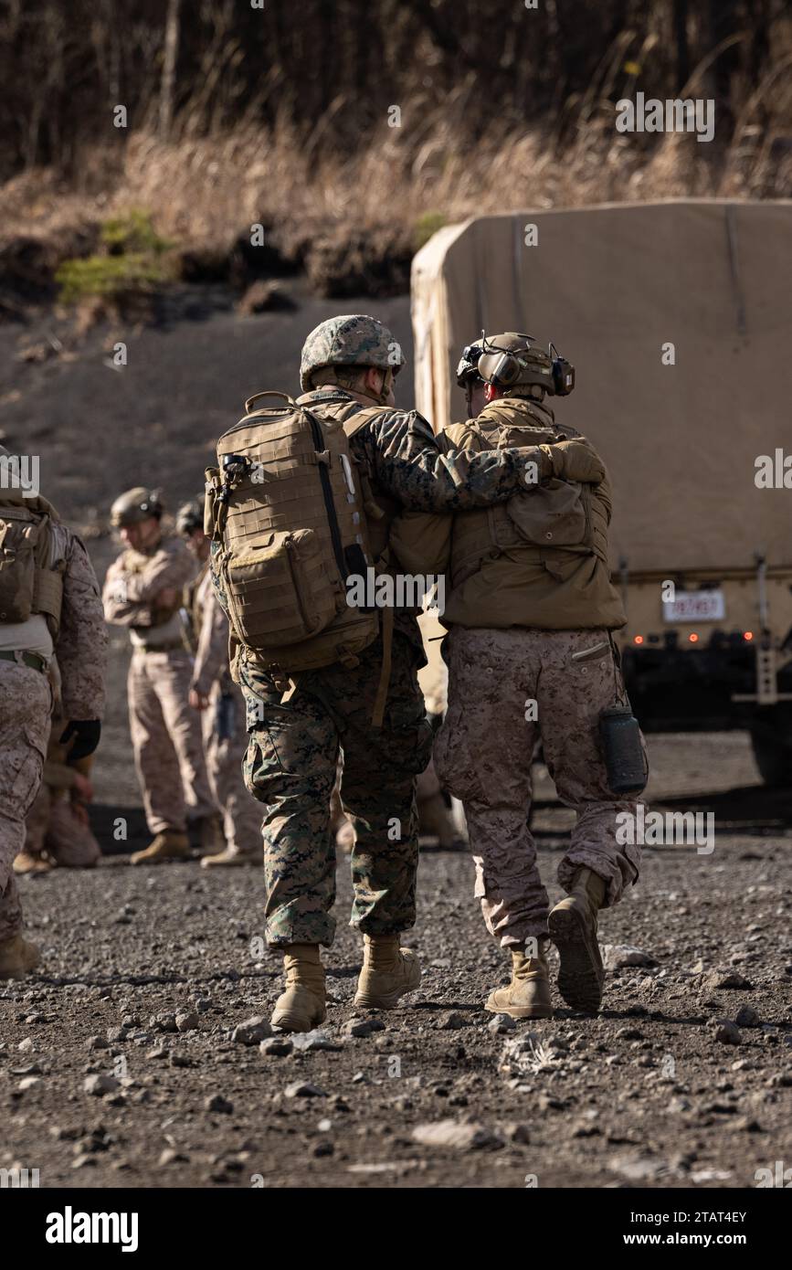 A U.S. Navy corpsman provides care to a U.S. Marine acting as a ...