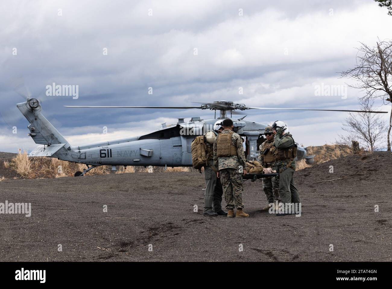 U.S. Marines and Navy corpsmen carry a casualty to a SH-60 Seahawk ...