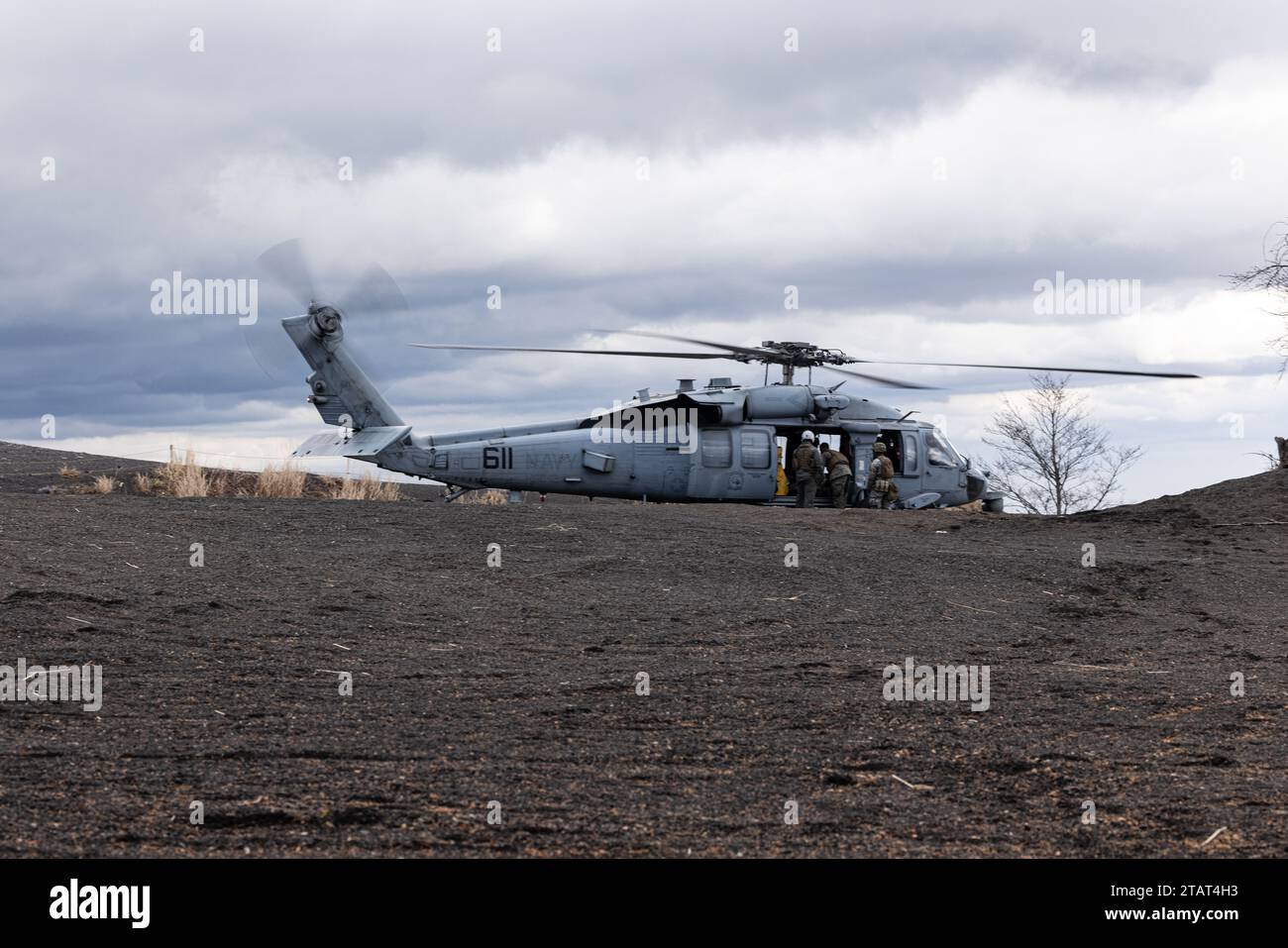 U.S. Marines and Navy corpsmen load a casualty onto a SH-60 Seahawk ...