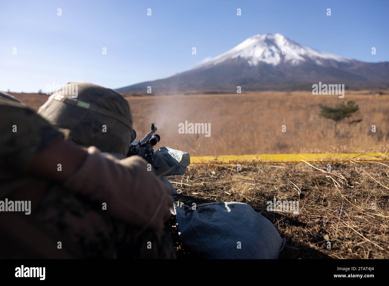 U.S. Marine Corps Cpl. Freeman Diah fires an M240B machine gun during ...