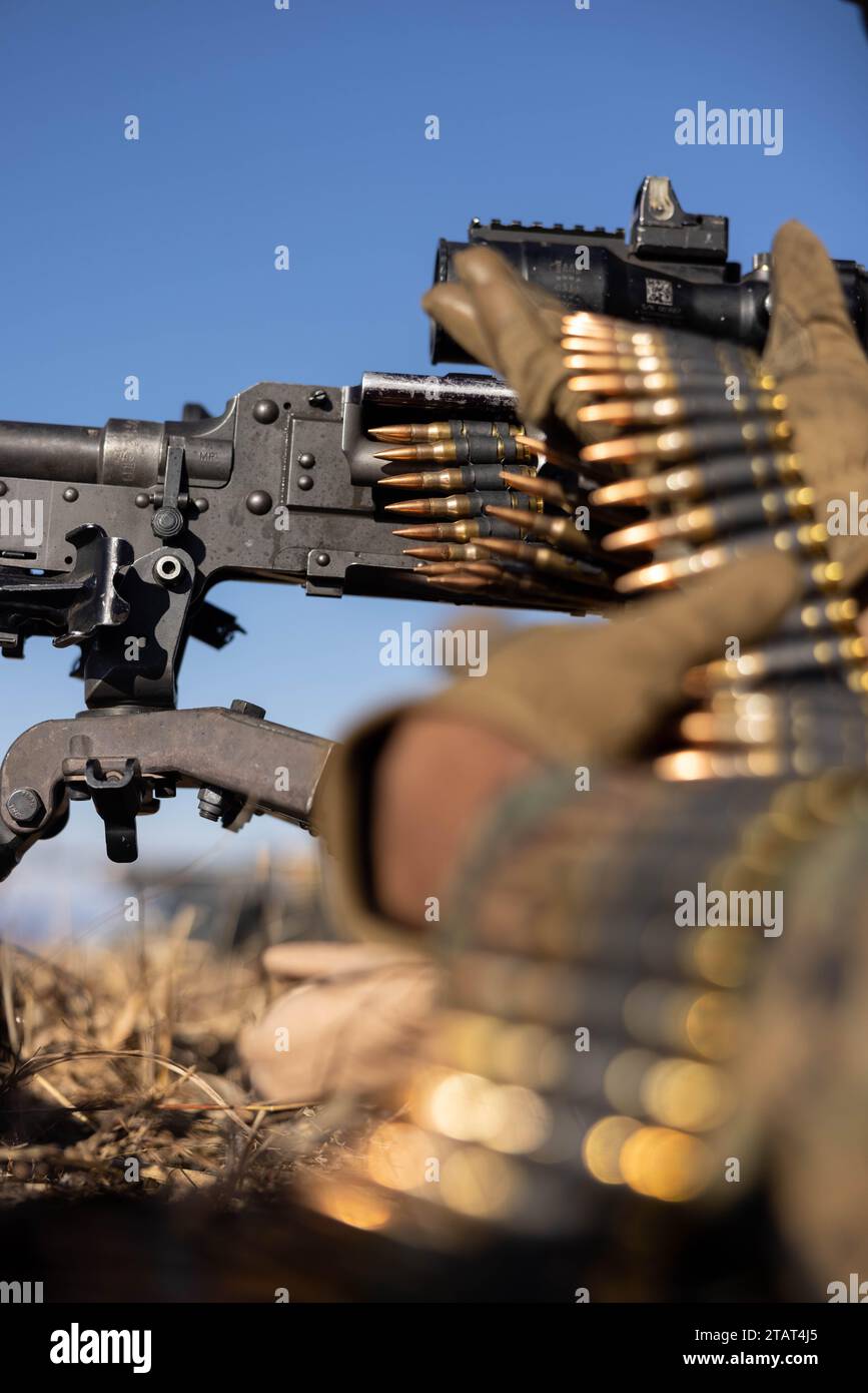 U.S. Marine Corps Lance Cpl. Jovanni Belloflores helps feed rounds into ...