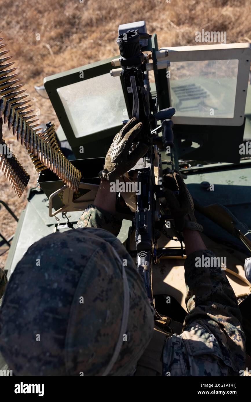 U.S. Marine Corps Lance Cpl. Waylon Madugno loads an M240B machine gun ...