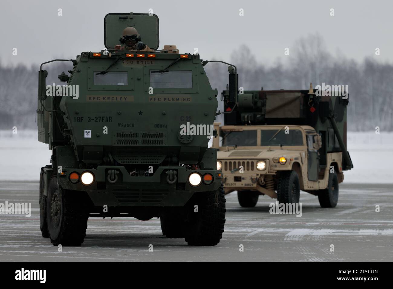 An M142 High-Mobility Artillery Rocket System (HIMARS) and a platoon ...