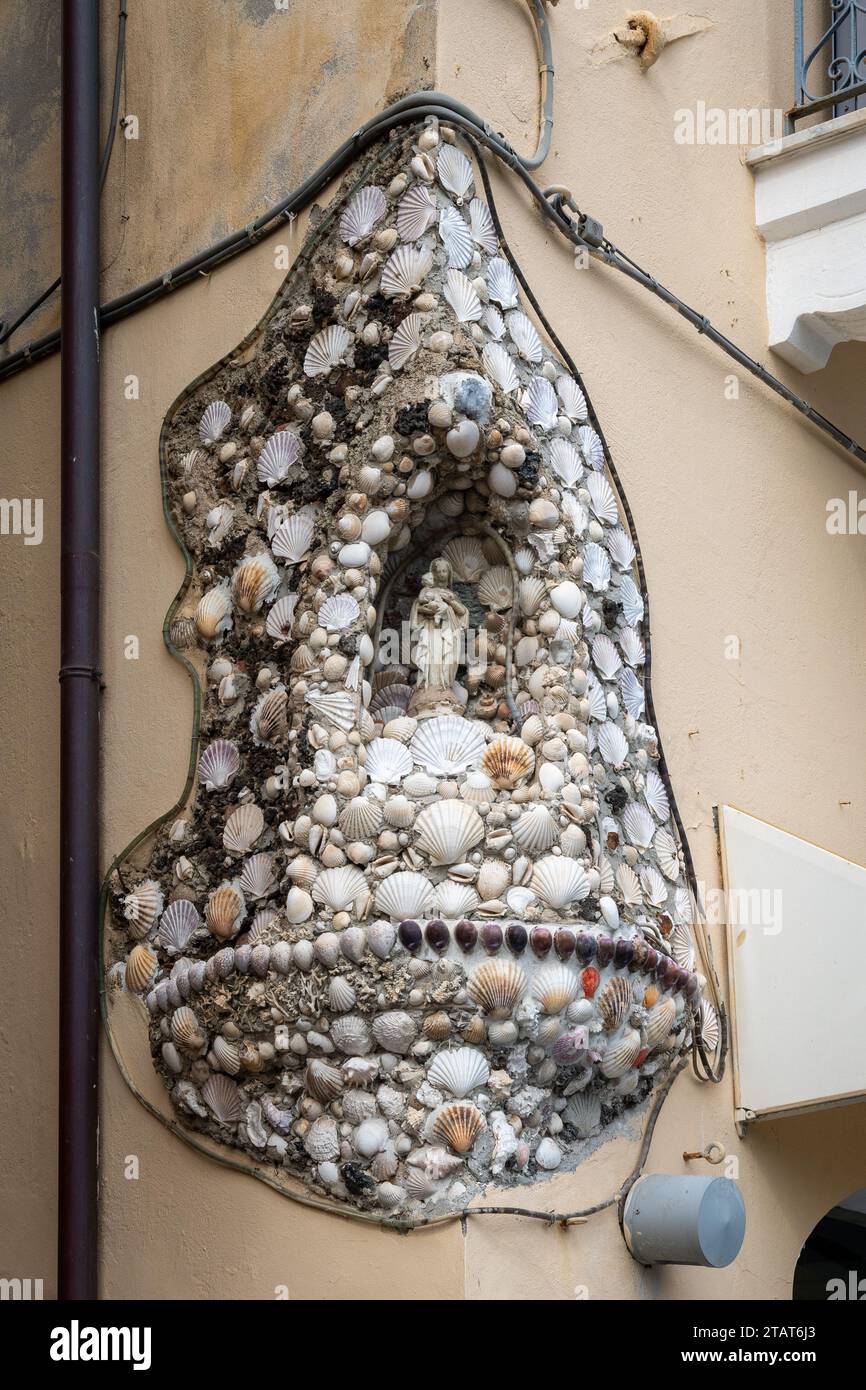 Votive shrine covered with shells dedicated to the Virgin Mary and Baby ...
