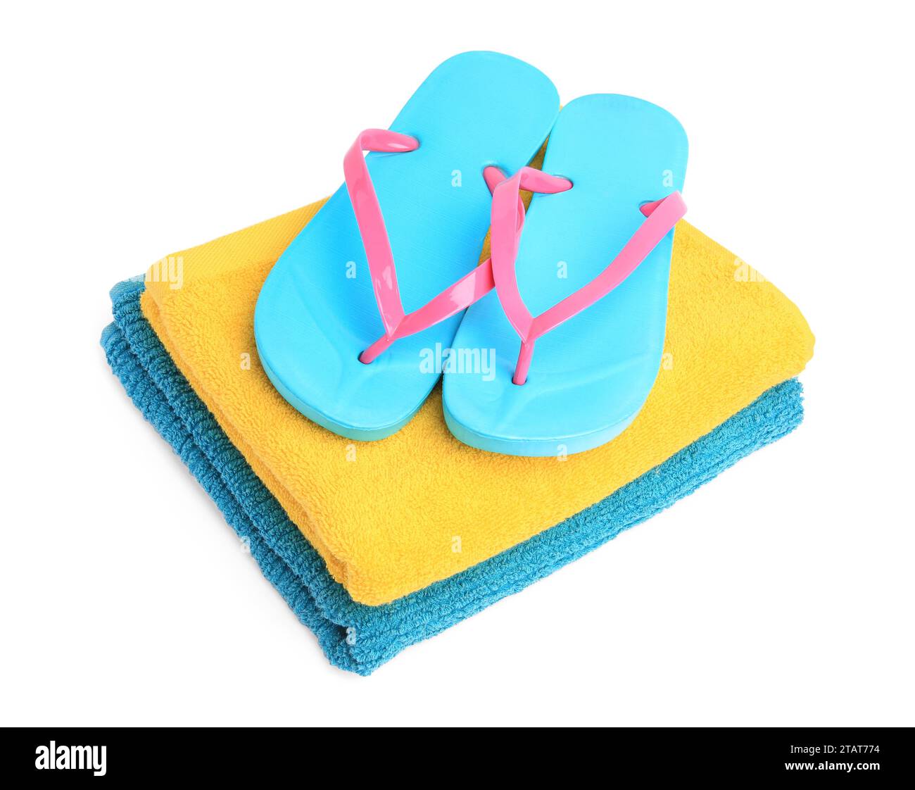 Colorful terry towels and flip flops isolated on white. Beach objects ...
