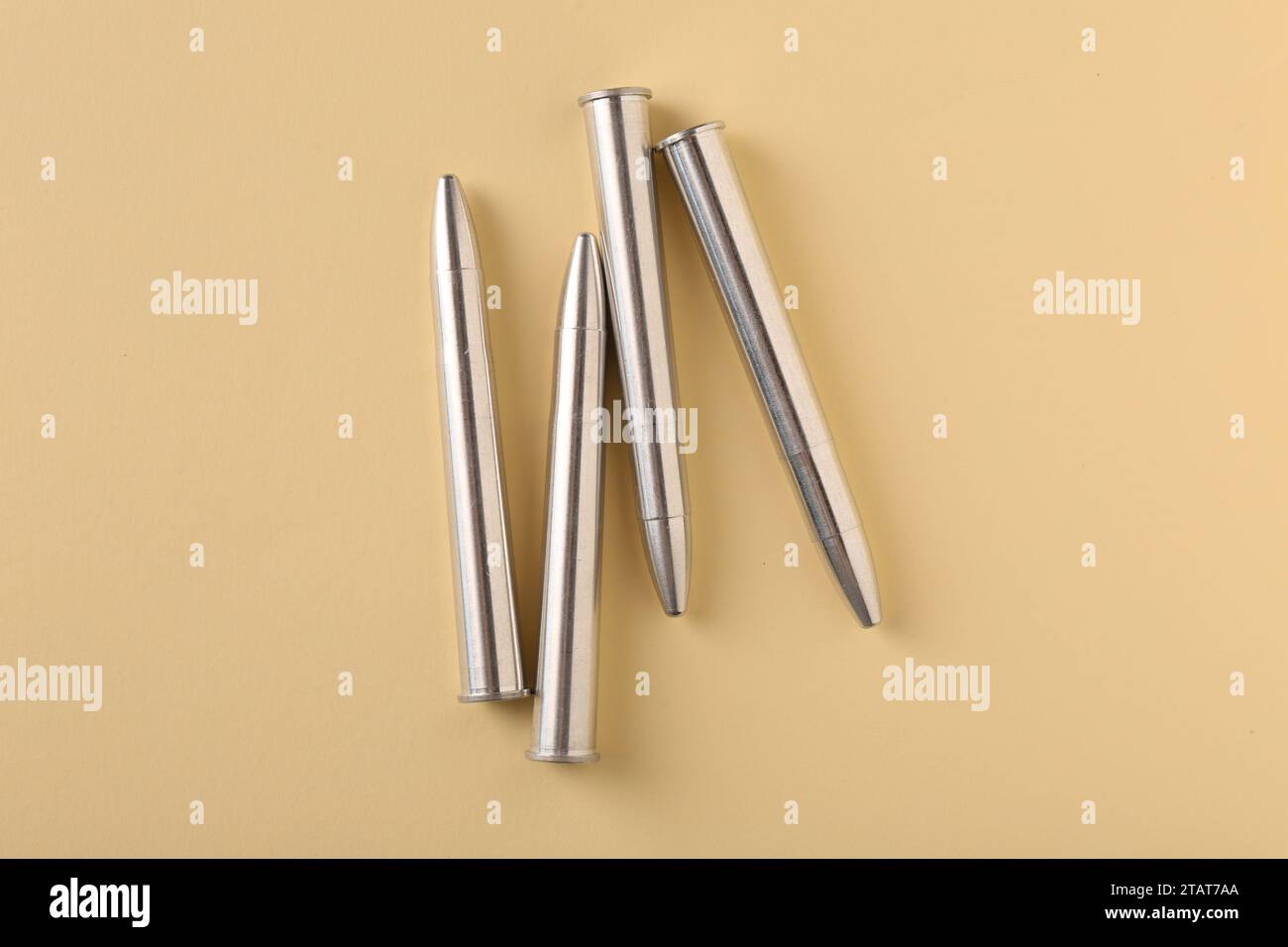 Many metal bullets on yellow background, flat lay Stock Photo - Alamy