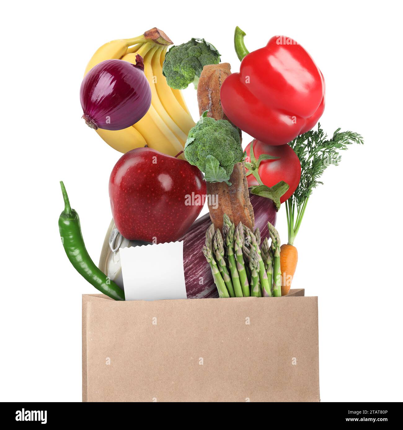 Different food products falling into paper bag on white background ...