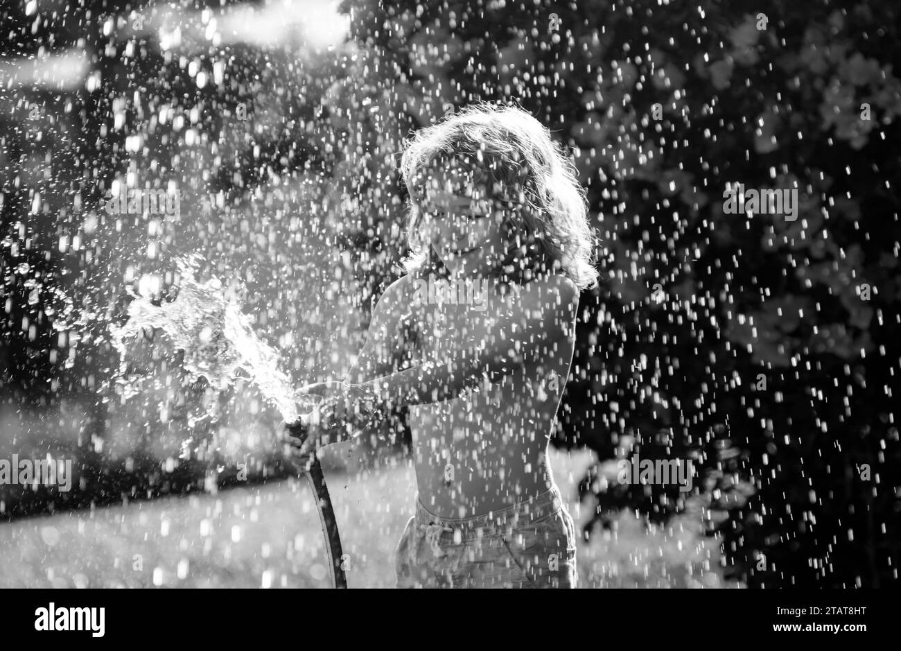 Kids play with water garden hose in yard. Outdoor children summer fun ...