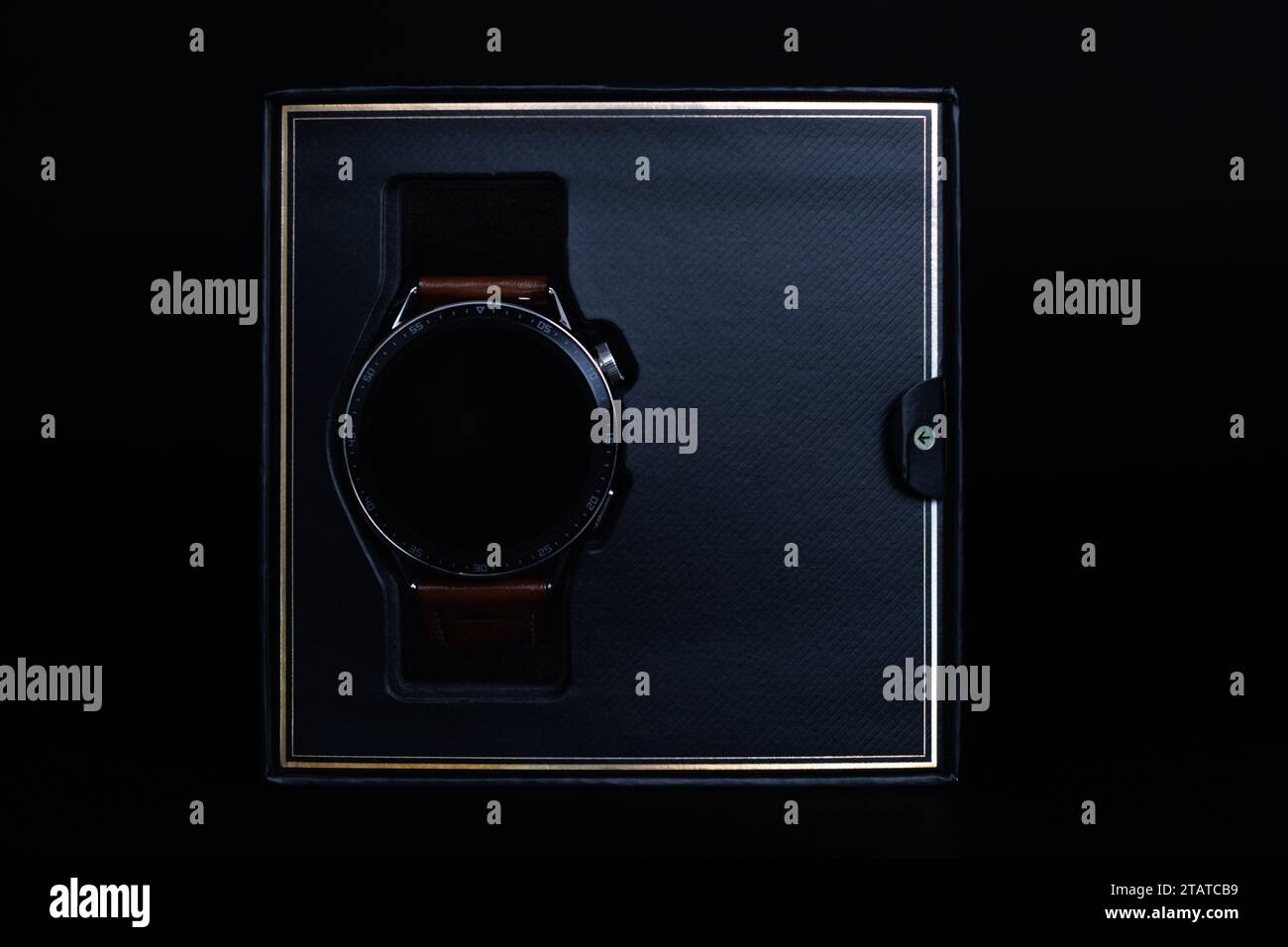 Smartwatch in the elegant black with gold strip on black background ...